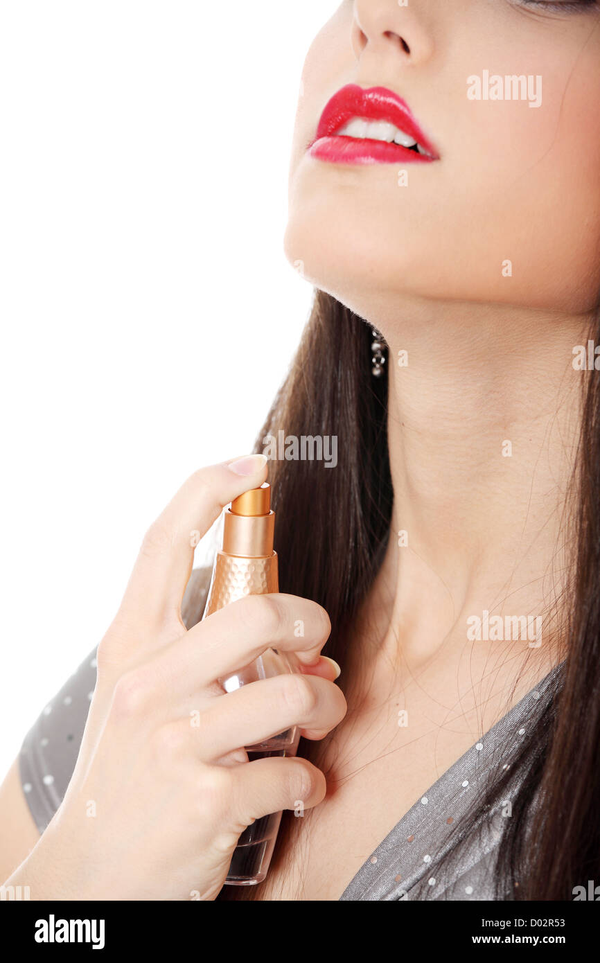 Beautiful woman applying perfume Stock Photo - Alamy