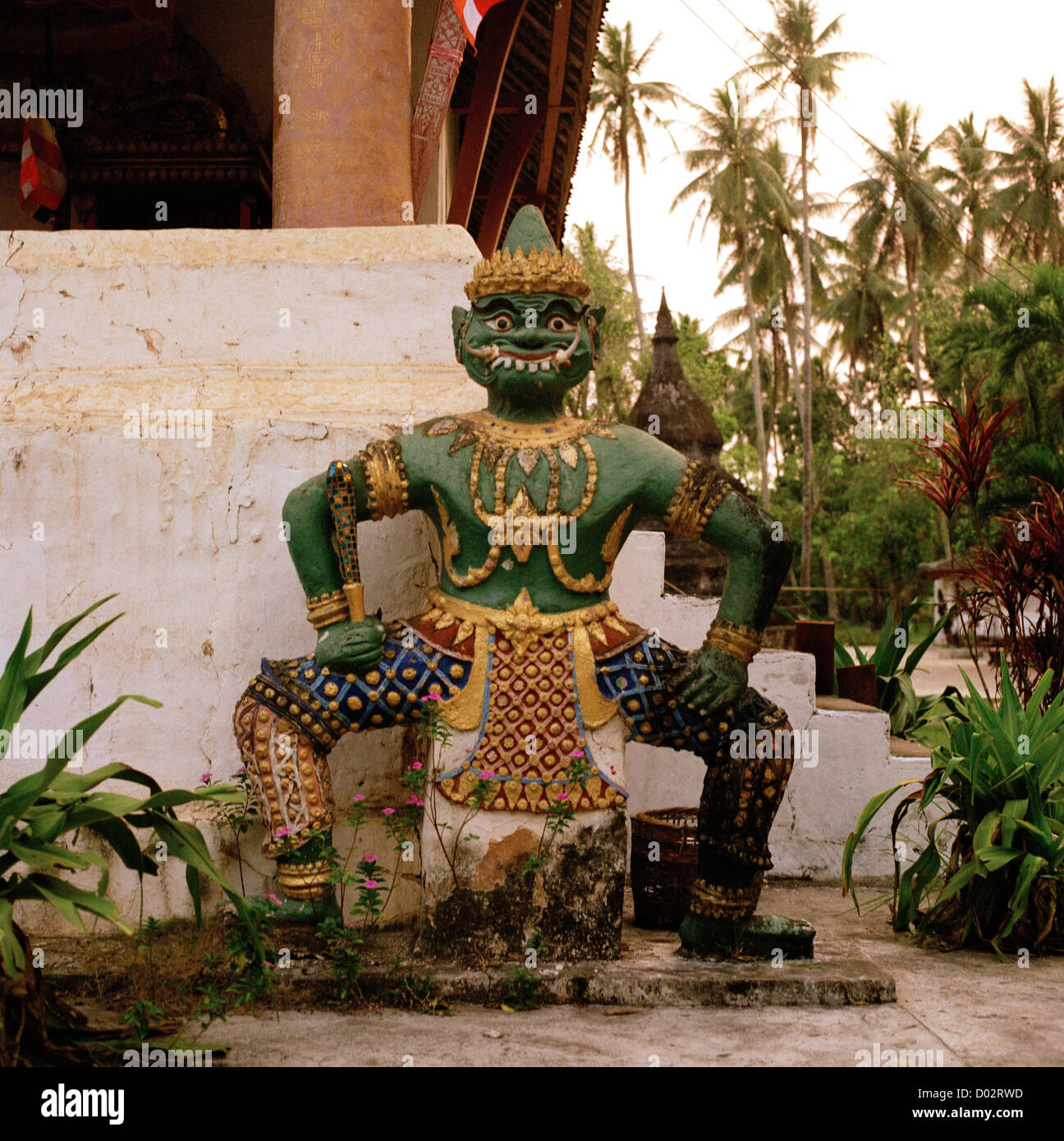 Demonic sculpture standing guard outside Buddhist temple Wat Aham in ...