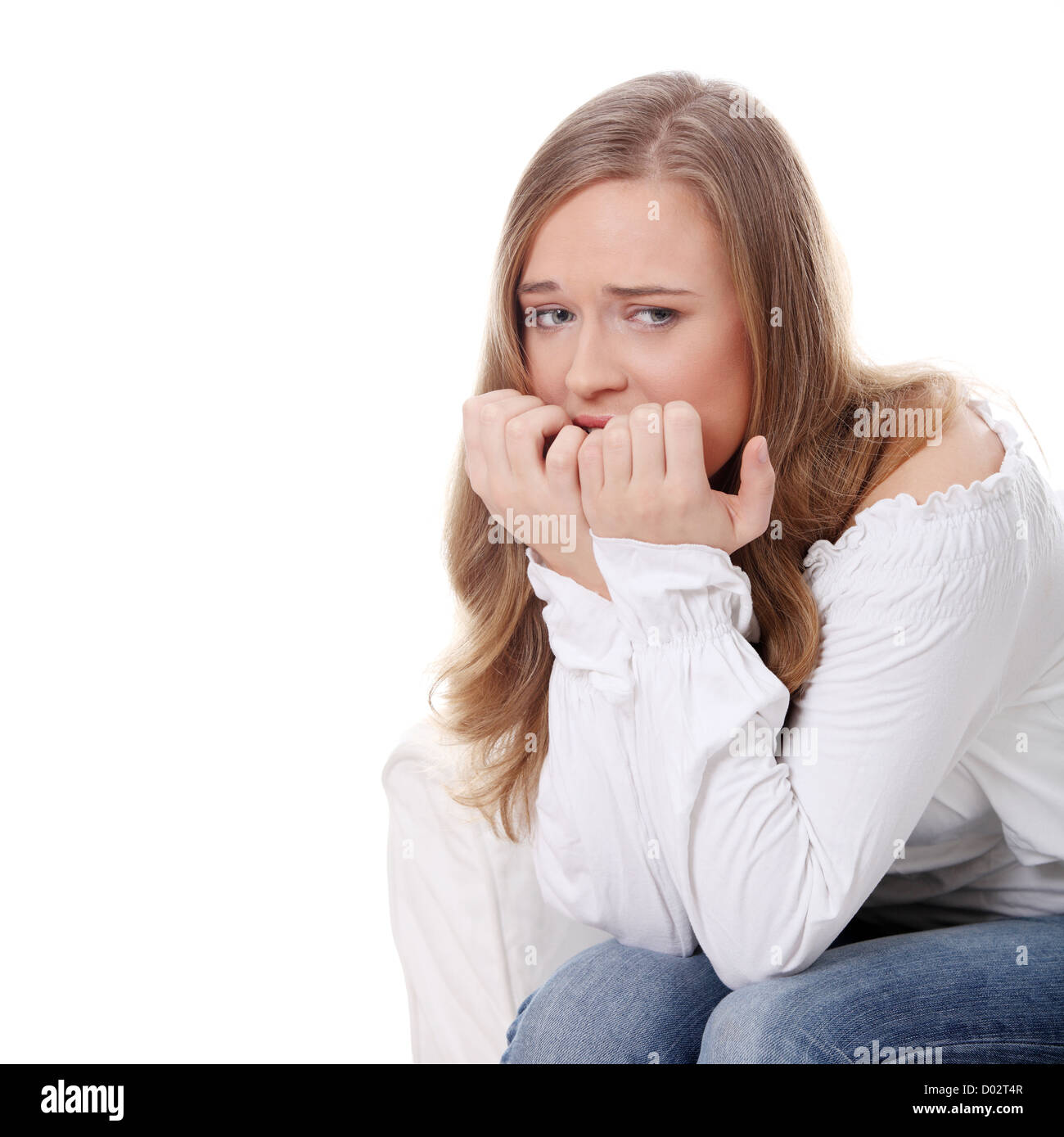 Stressed young woman eating her nails Stock Photo - Alamy