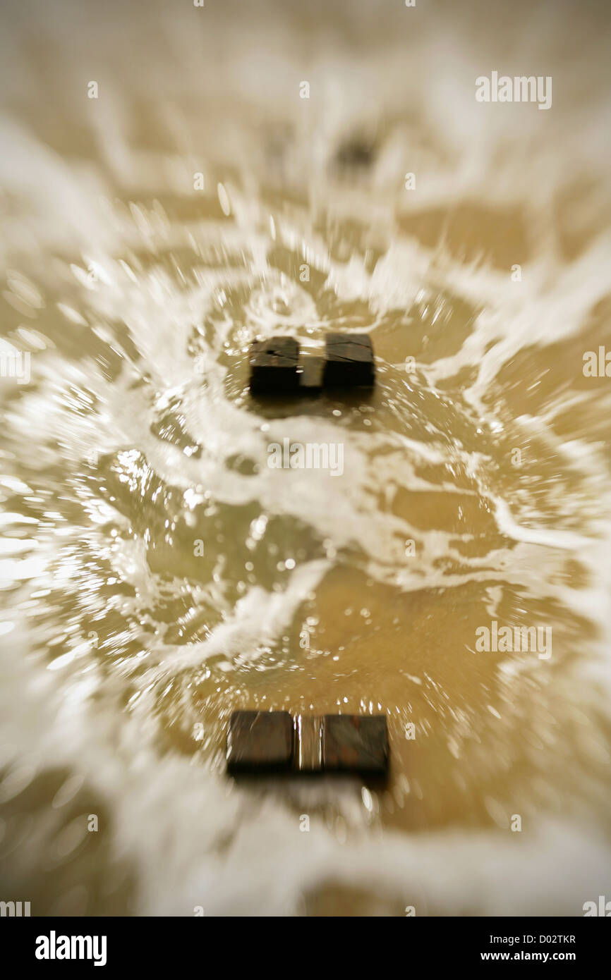 Seawater swirling around timber sea defence groynes, Bridlington, North ...
