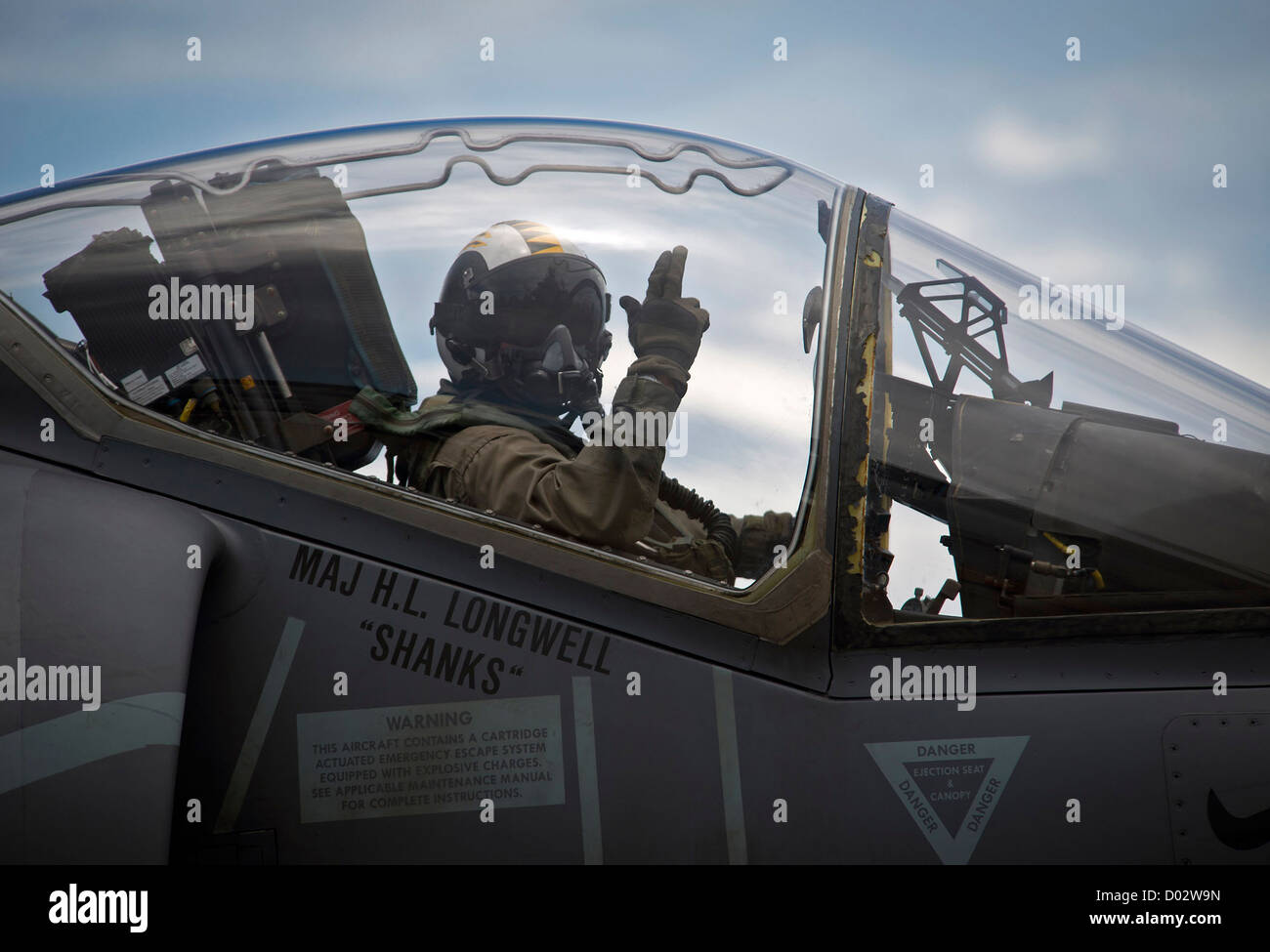 A US Marine pilot waves from the cockpit of an AV-8B Harrier jet ...