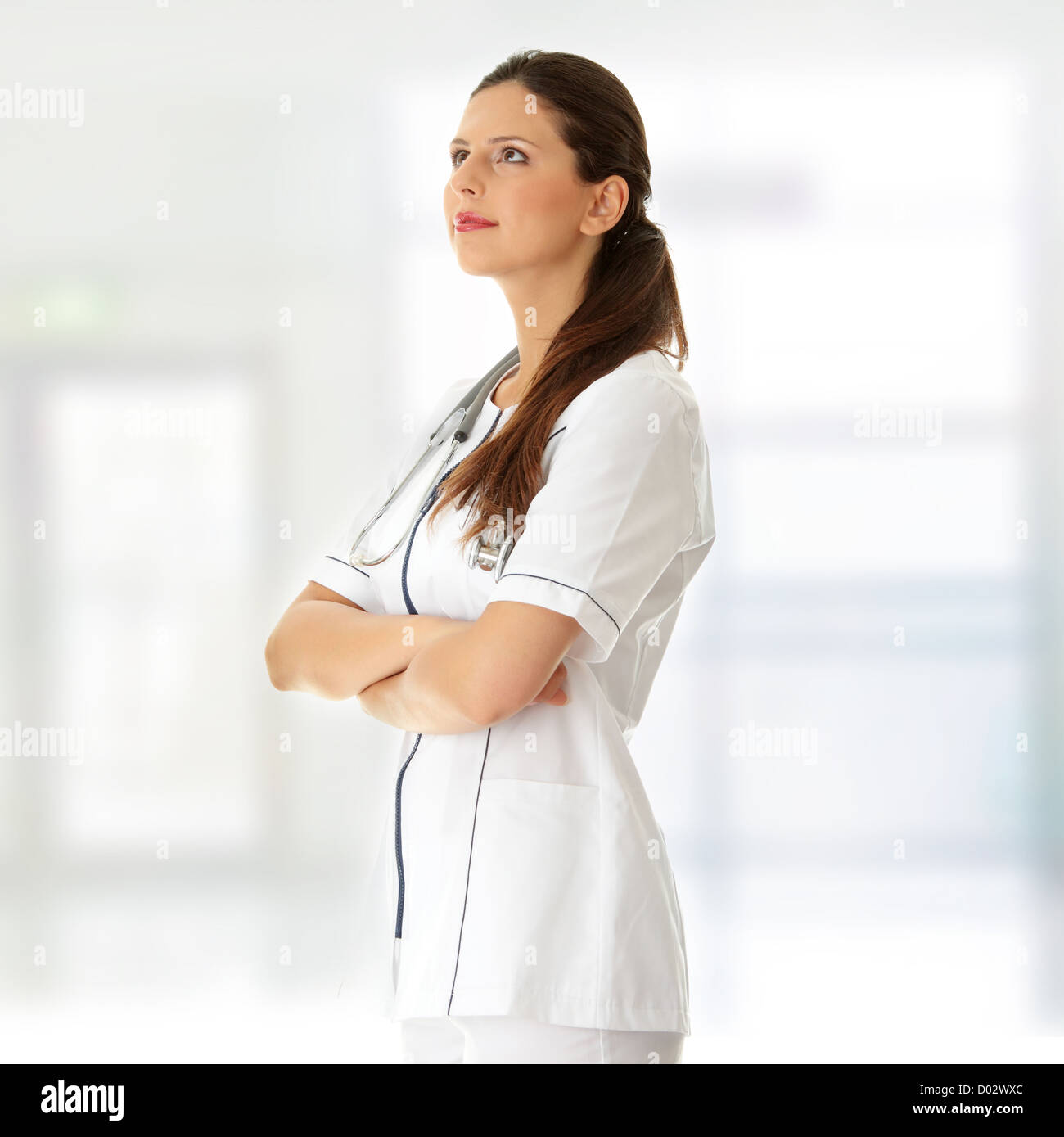 Female doctor looking upper left corner Stock Photo - Alamy