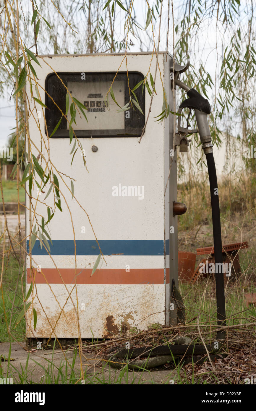 Old, rusty and abandoned gas pump against nature Stock Photo - Alamy