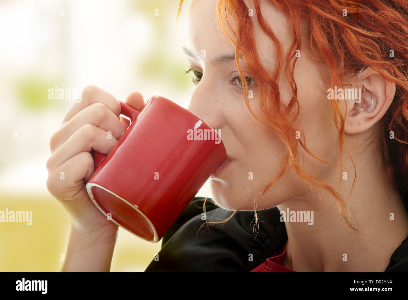 Beautiful deaf woman drinking coffee Stock Photo - Alamy