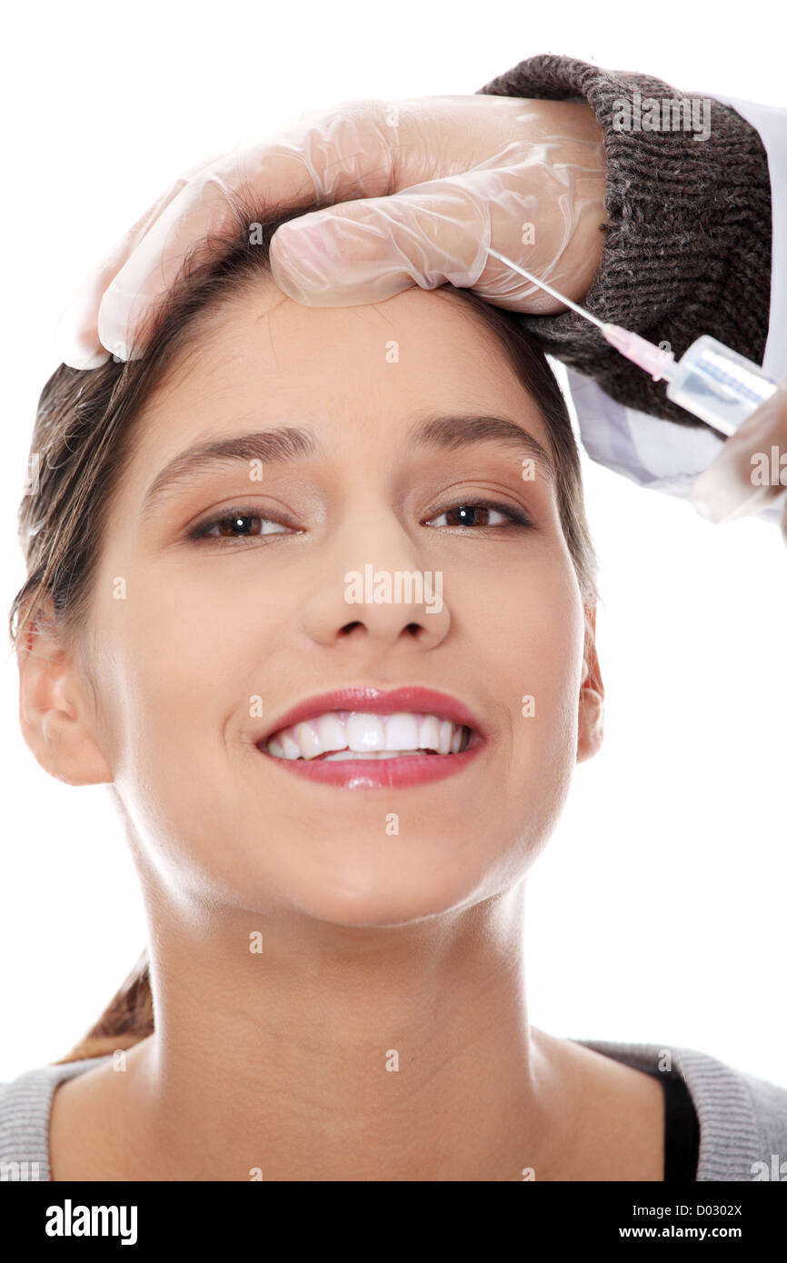 Plastic surgeons giving botox injection in female skin. Isolated on ...