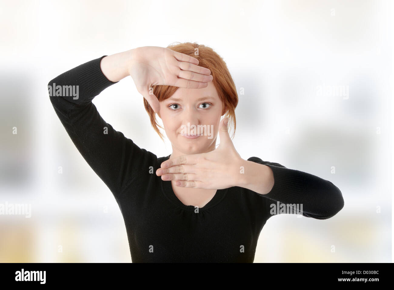 Young attractive woman framing her face with hands Stock Photo - Alamy