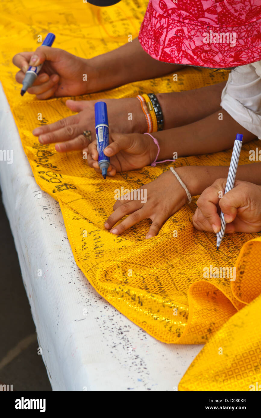 Buddhists writing Wishes on a yellow Ribbon of the Temple Wat Arun in ...