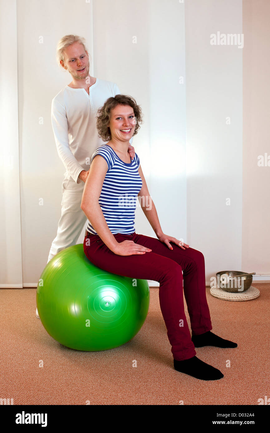 adult practicing poses on exercise ball with professional Stock Photo ...