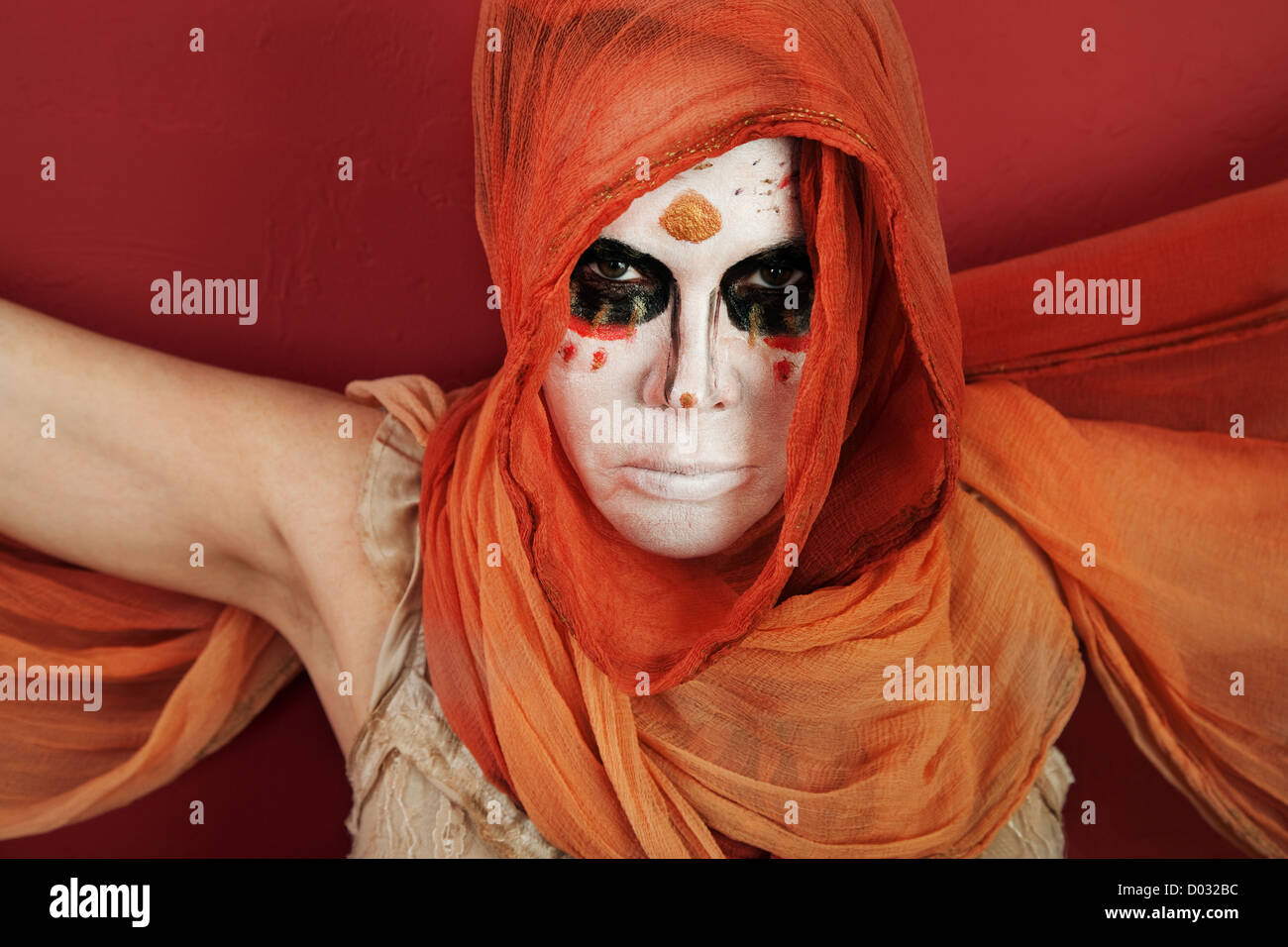 Woman in an orange scarf and wraith makeup Stock Photo - Alamy