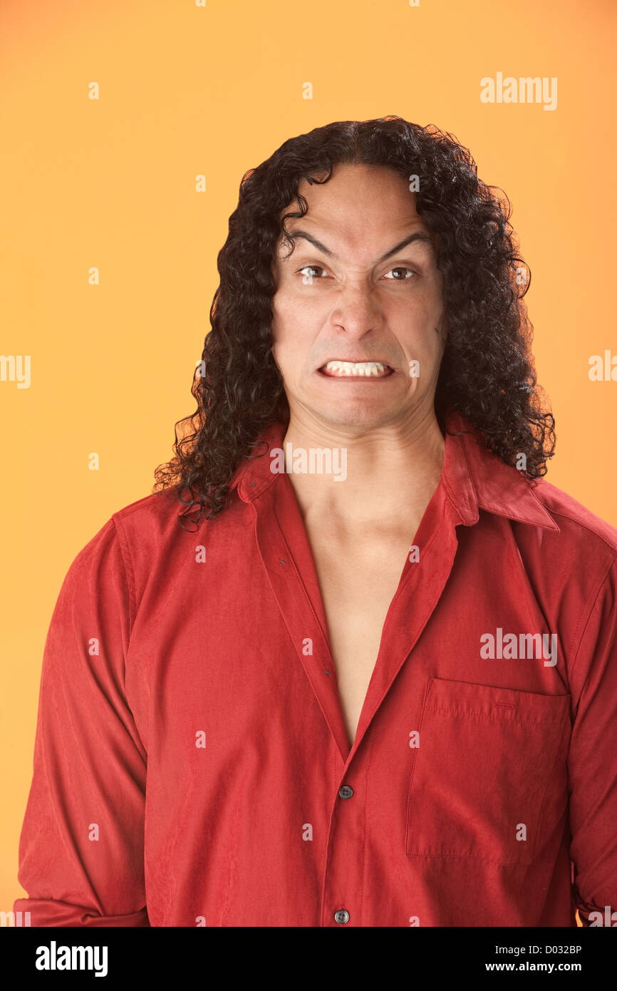 Muscular Latino man clenches his teeth in anger Stock Photo - Alamy