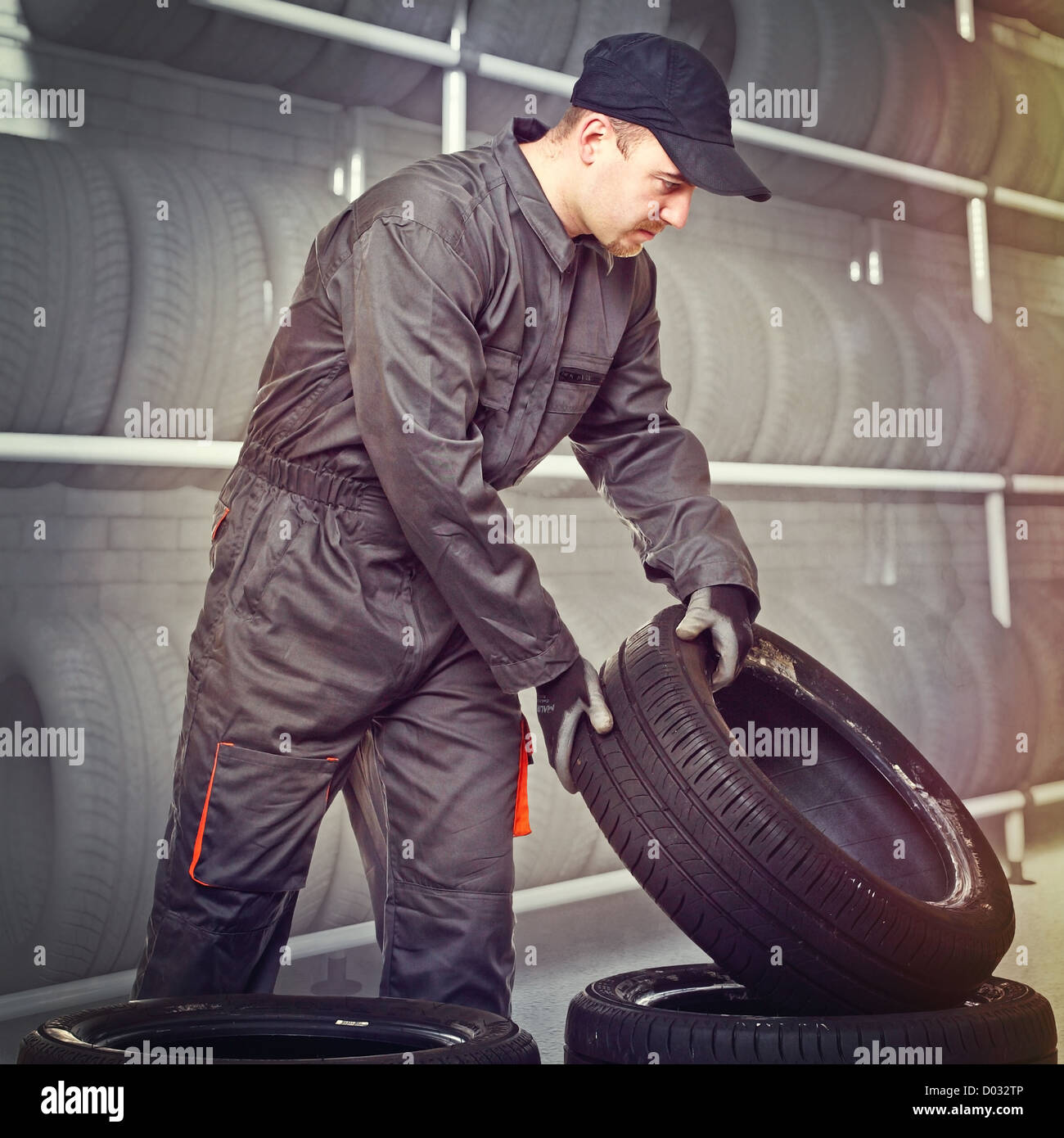 garage worker move some tires Stock Photo - Alamy