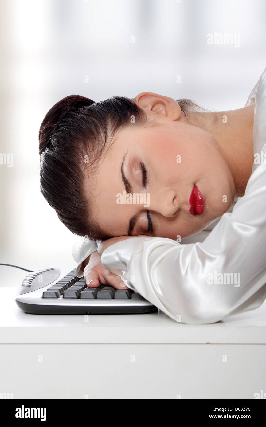 Young businesswoman sleeping on the keyboard in the office Stock Photo ...
