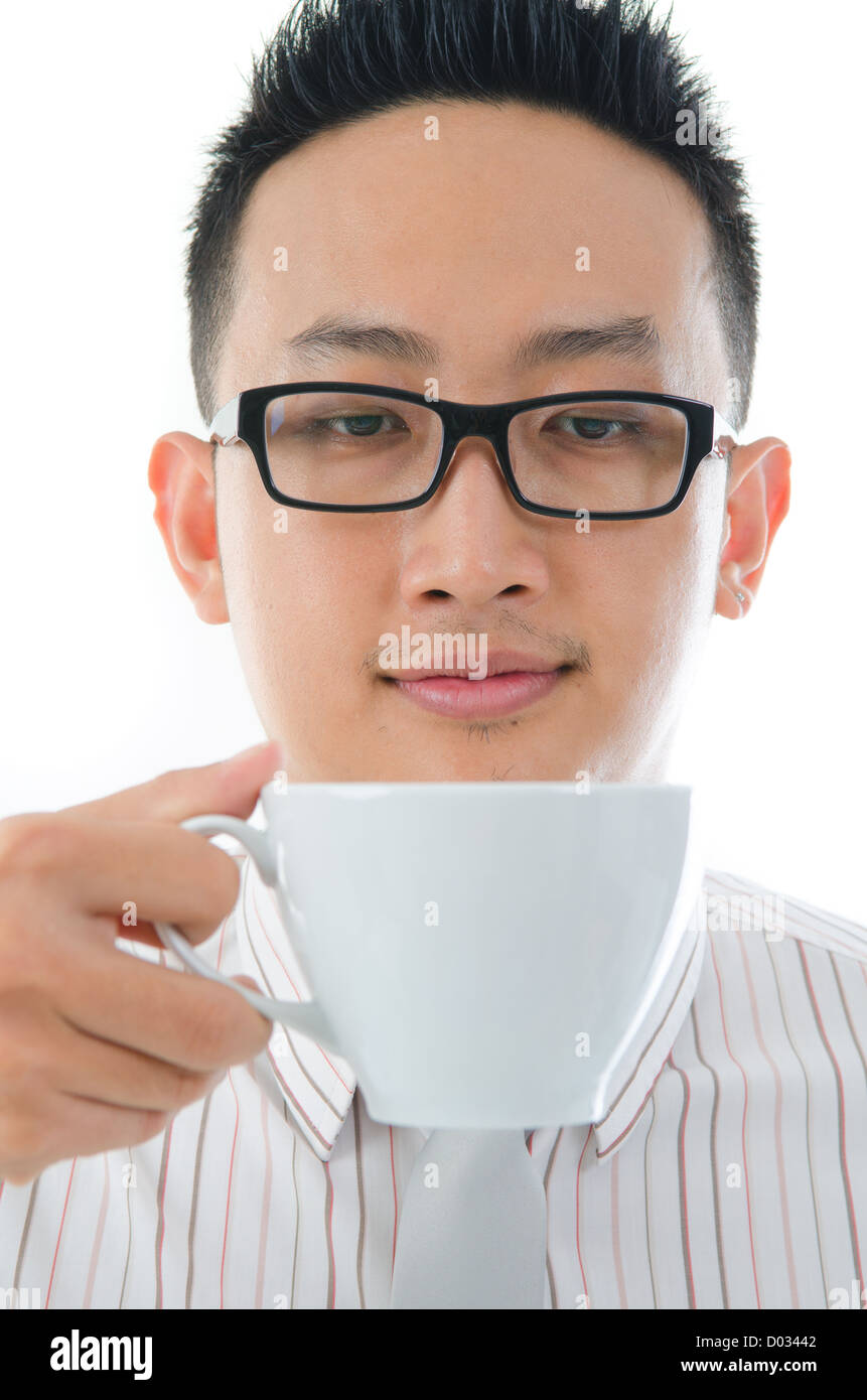 asian man having tea or coffee break, zoom on face Stock Photo - Alamy