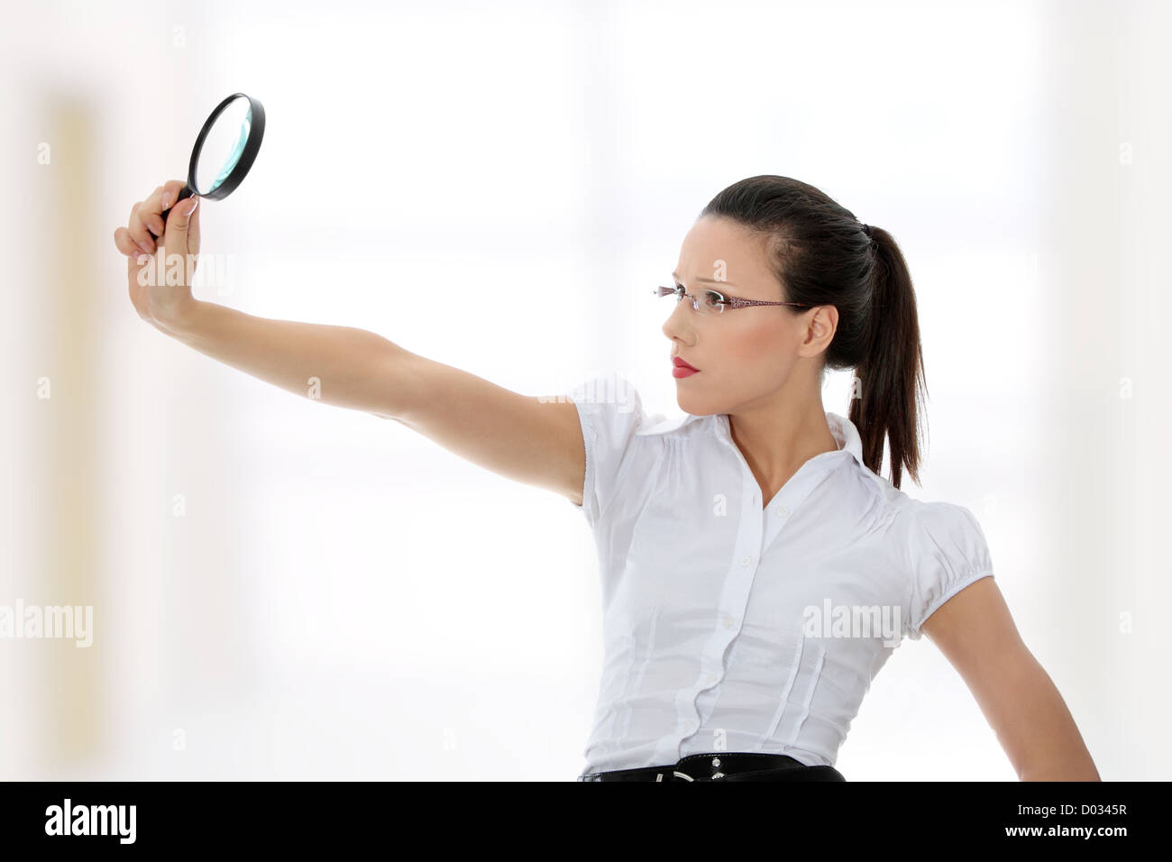 Business woman holding magnifying glass Stock Photo - Alamy