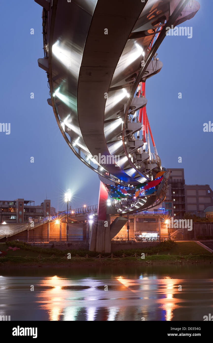Colorful bridge in red over river in night in modern city in Taipei ...