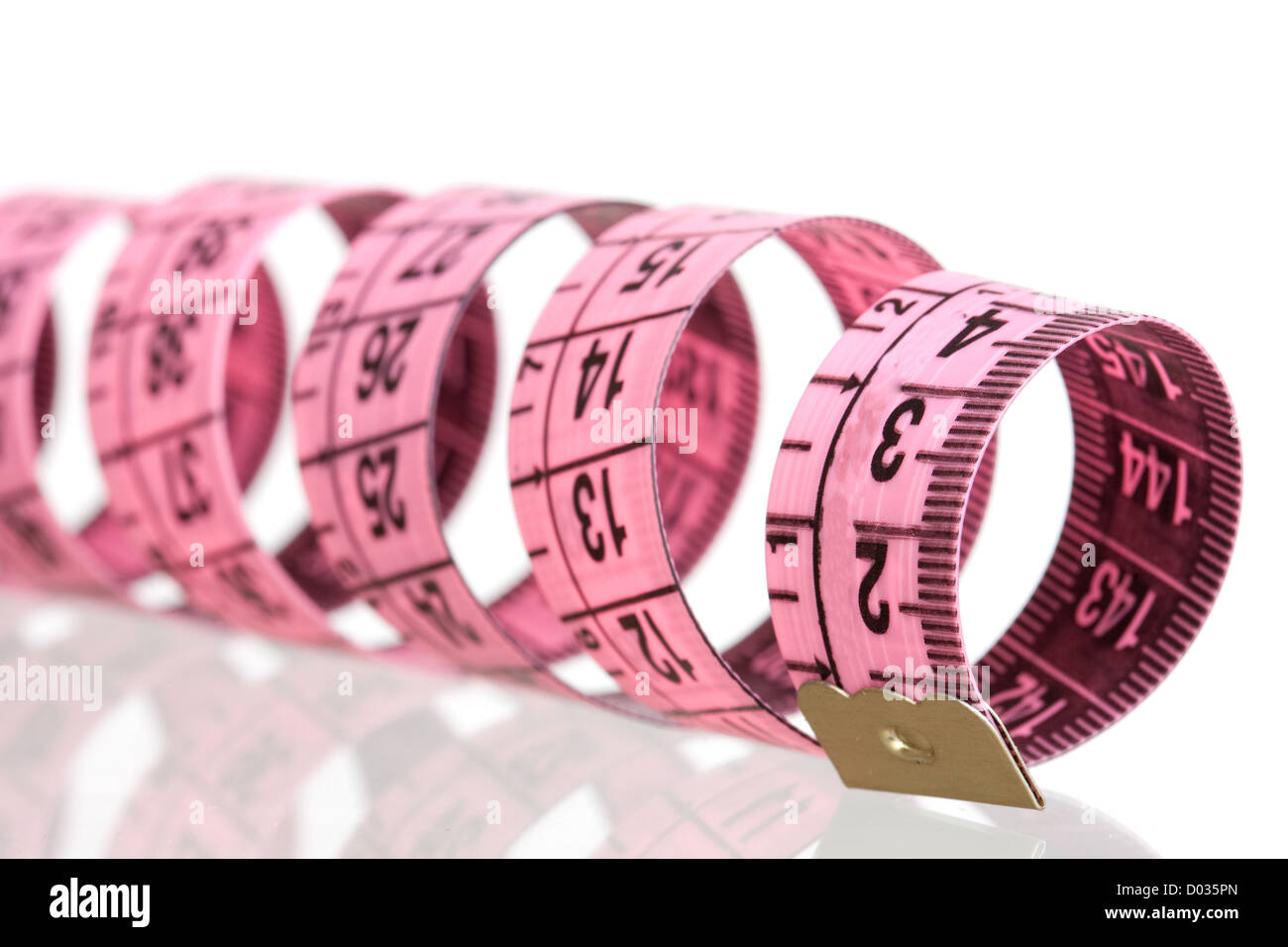 Pink tape measure with reflection on the floor isolated on white ...