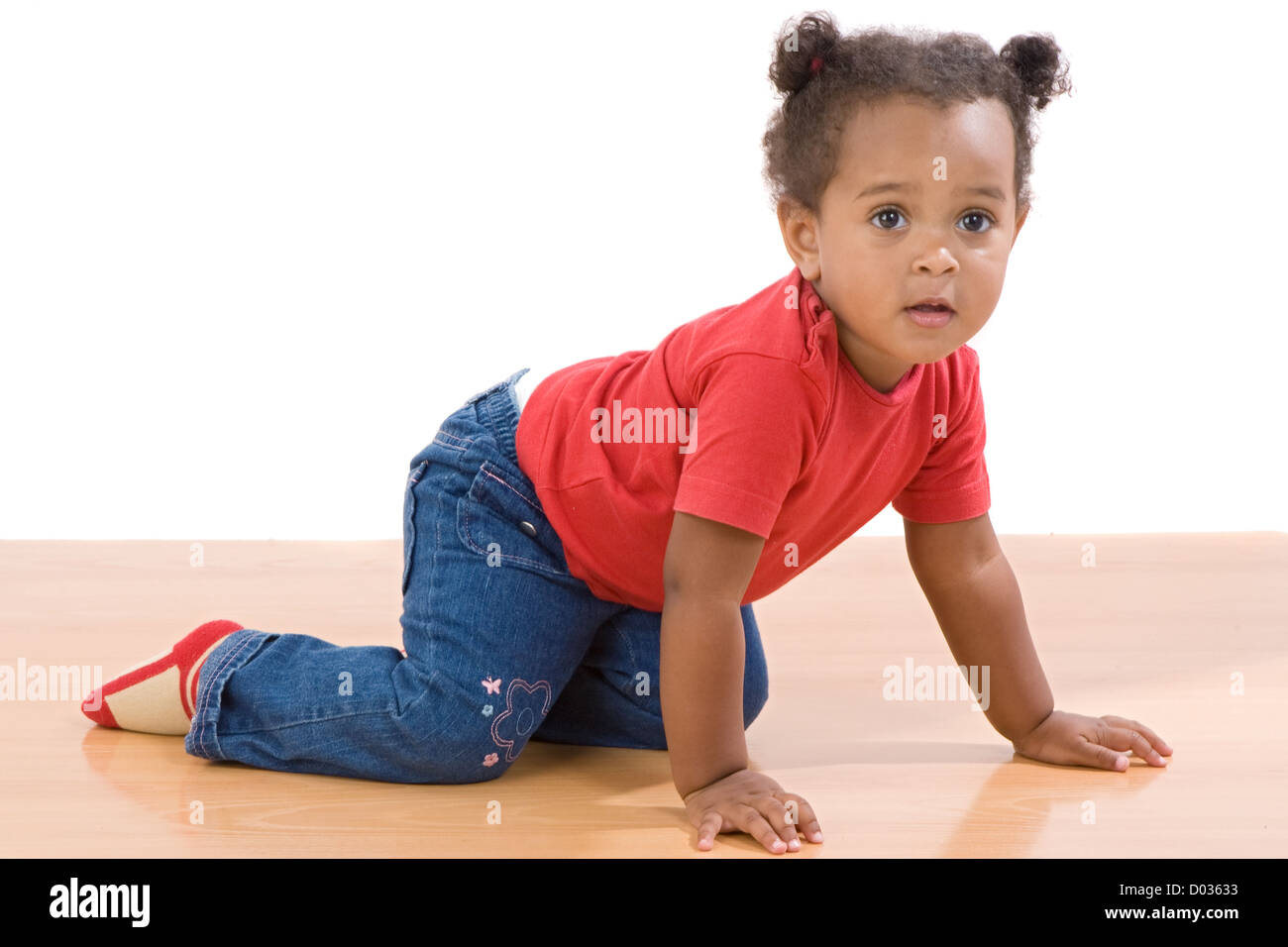 Adorable african baby crawl over wooden floor Stock Photo - Alamy