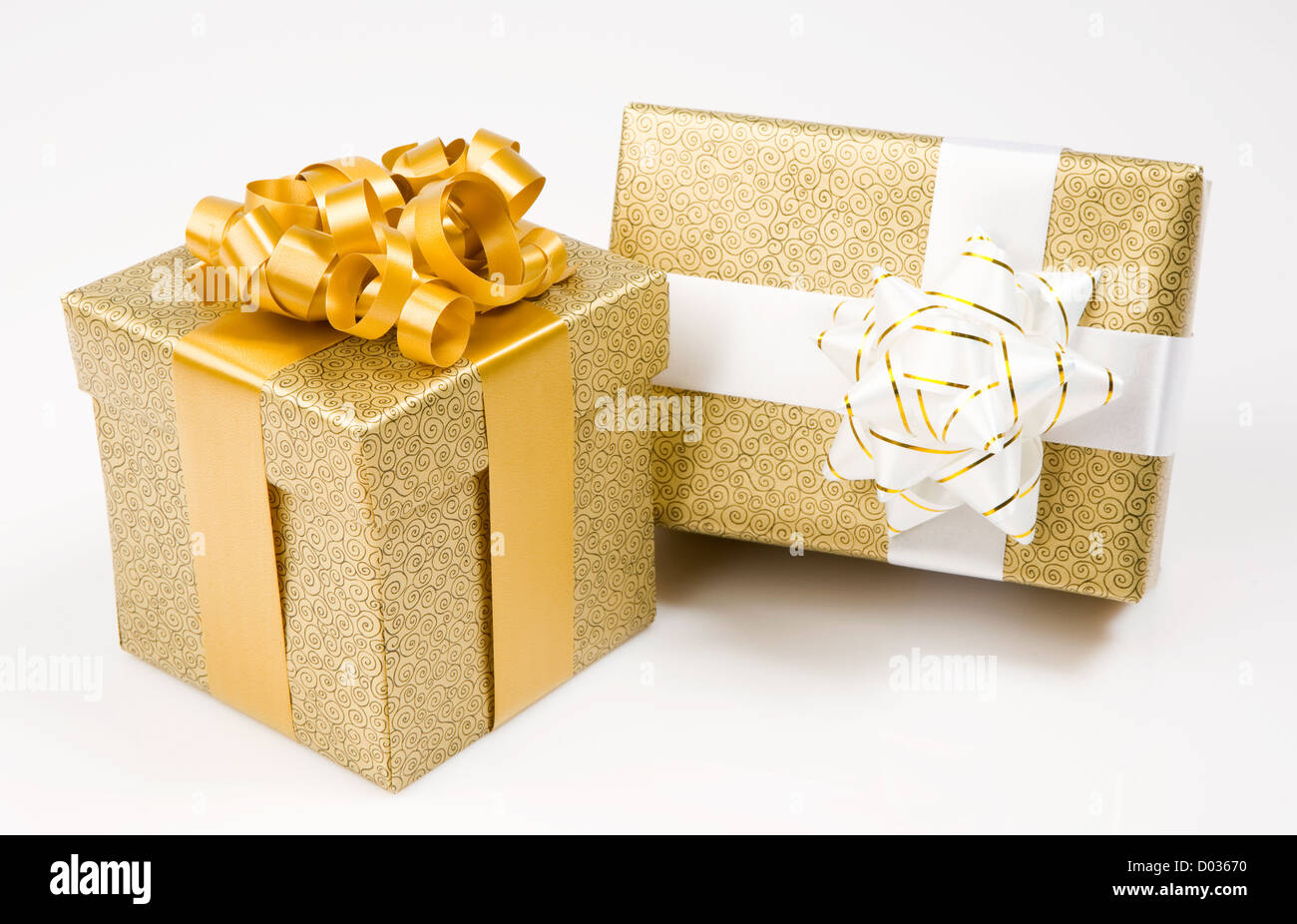 Beautiful golden gifts on a over white background Stock Photo - Alamy