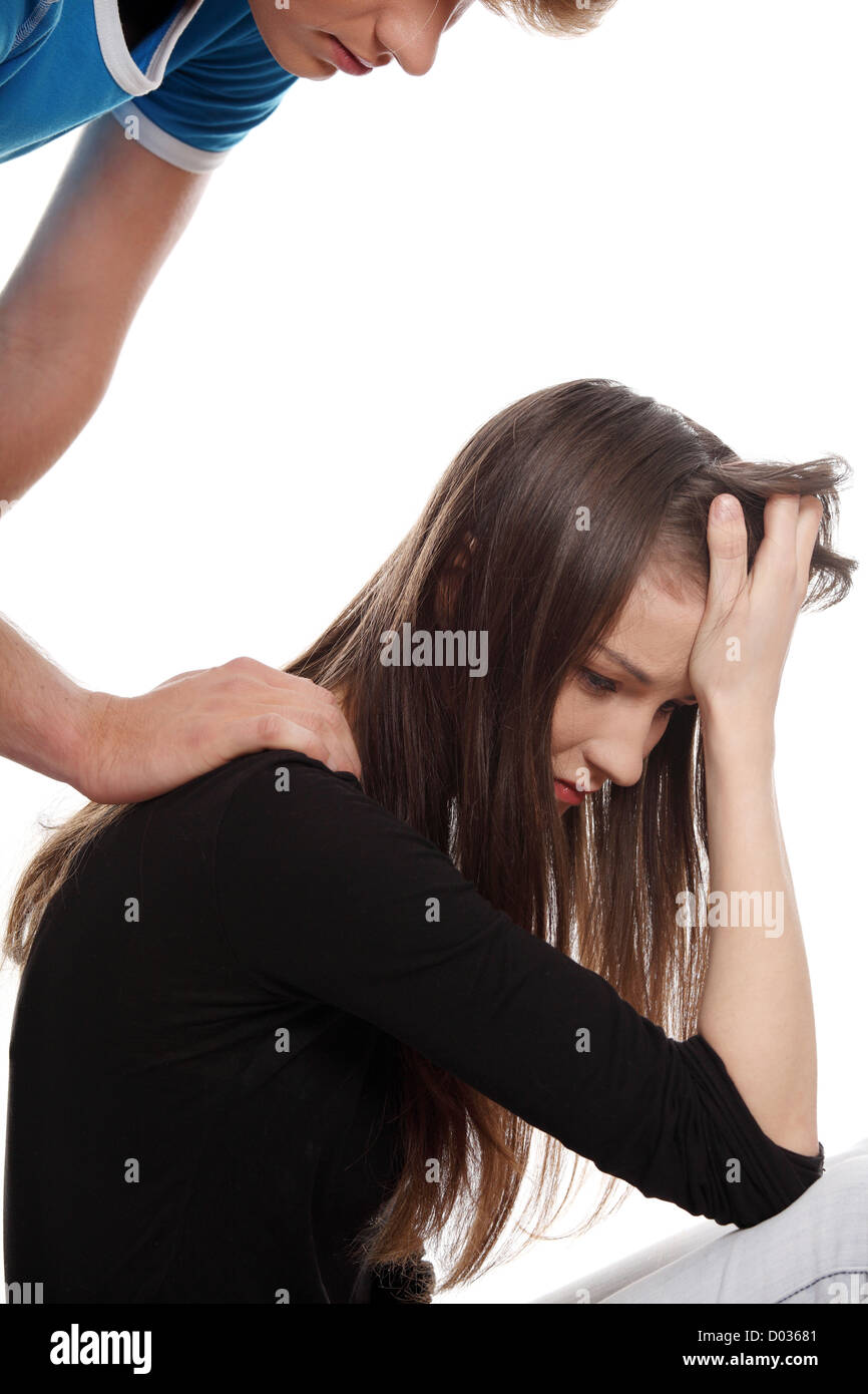 Troubled young girl comforted by her boyfriend. Isolated on white ...
