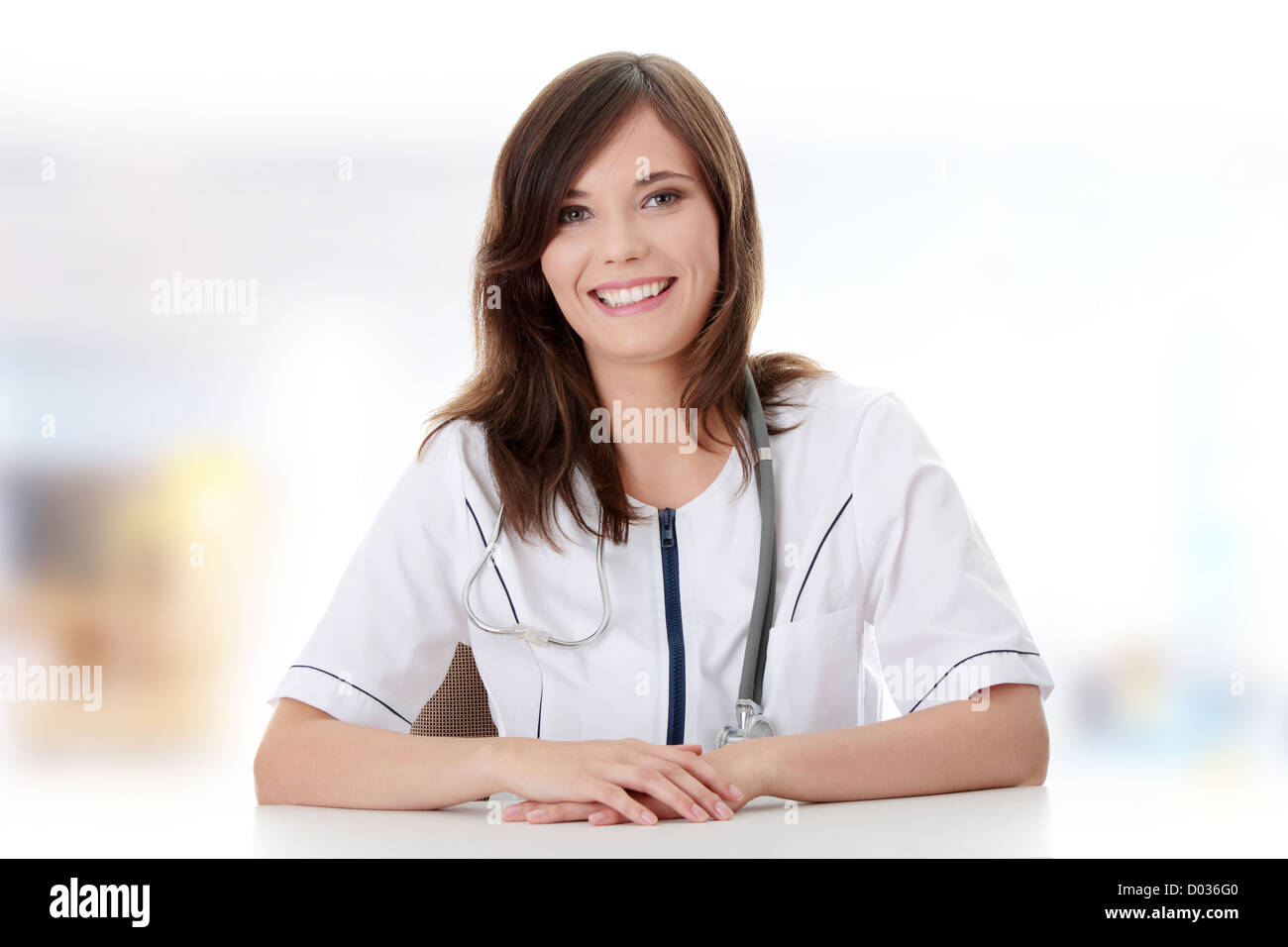 Female doctor or nurse sitting at the desk Stock Photo - Alamy