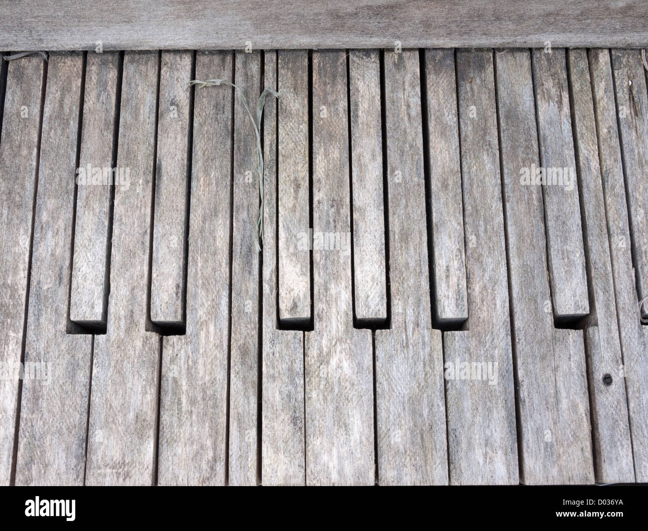 A decaying old piano which is weathered due to being left outside. It ...