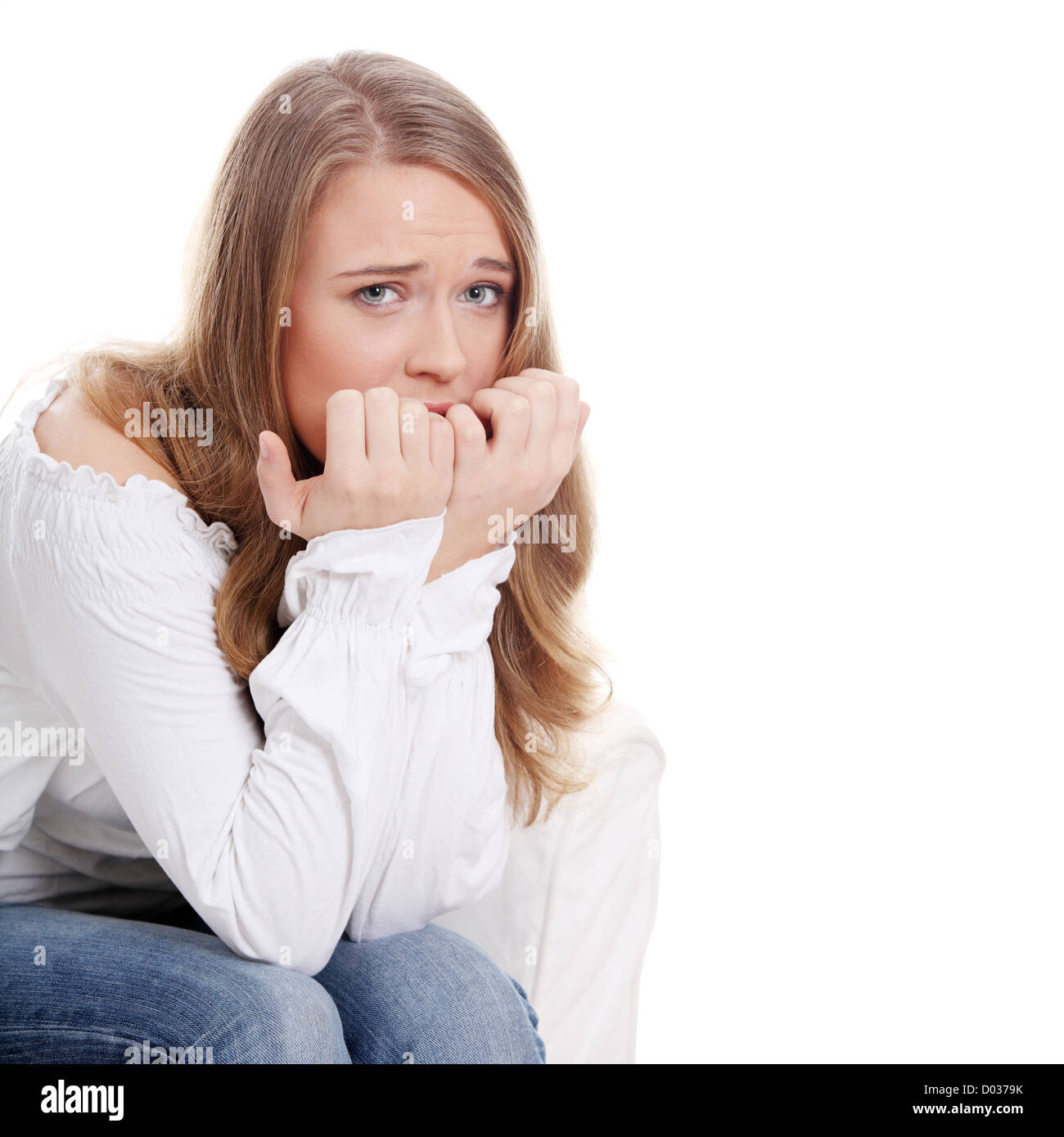 Stressed young woman eating her nails Stock Photo - Alamy