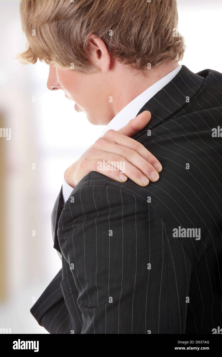 Businessman holding his hand to his aching back Stock Photo - Alamy