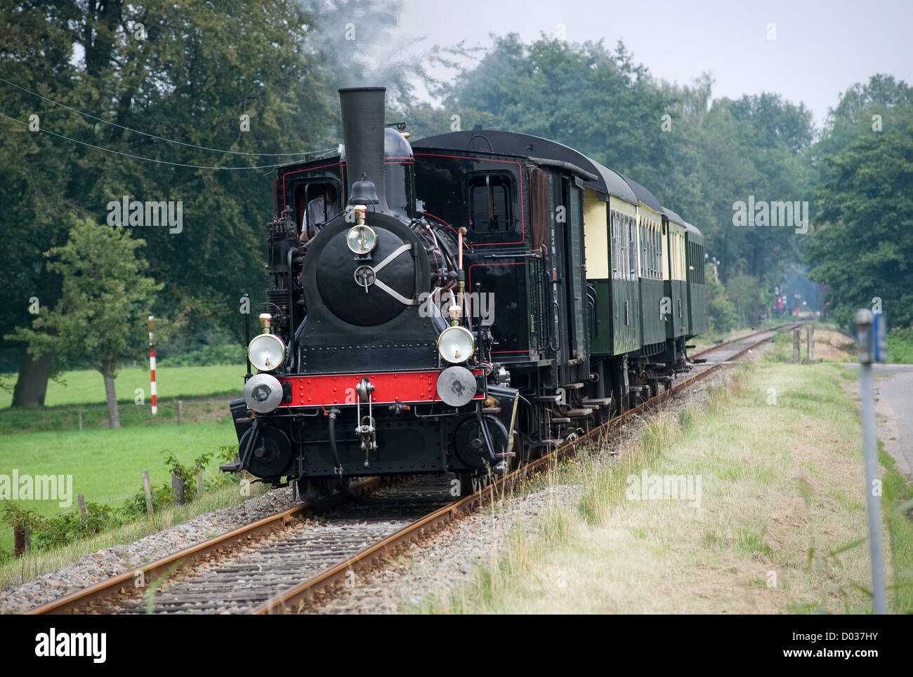 Old restored steam train with wagons still riding for fun with tourists ...