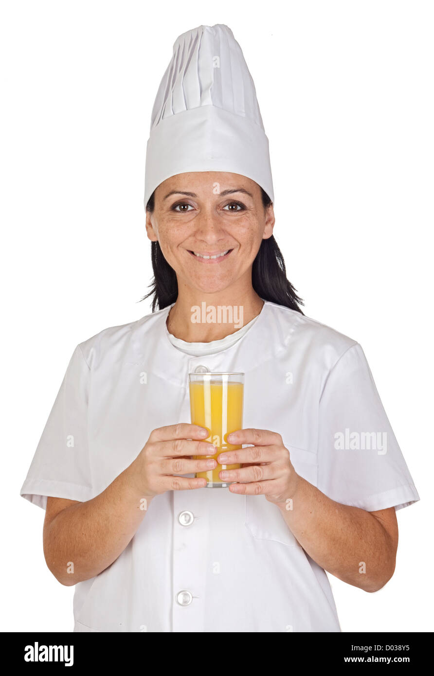 Pretty cook girl with a glass of orange juice isolated on white ...