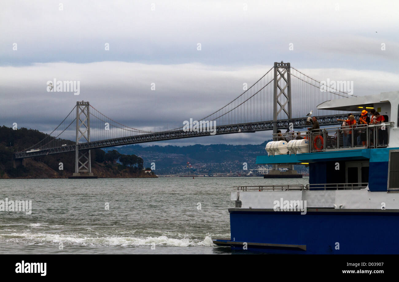 A ferry boat passes with San Francisco-Oakland Bay Bridge and Yerba ...