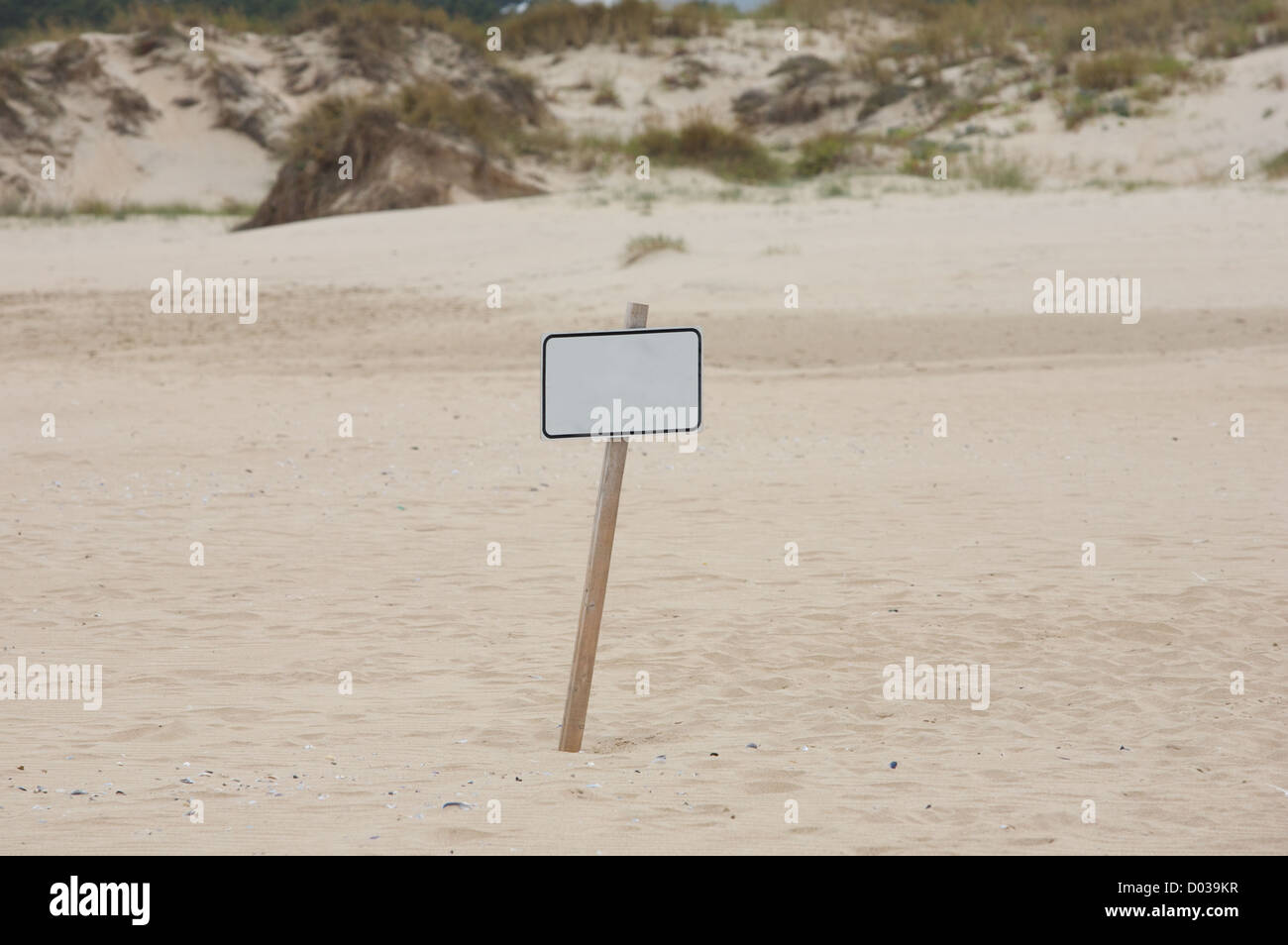 Lonely poster in the middle of the sand Stock Photo - Alamy