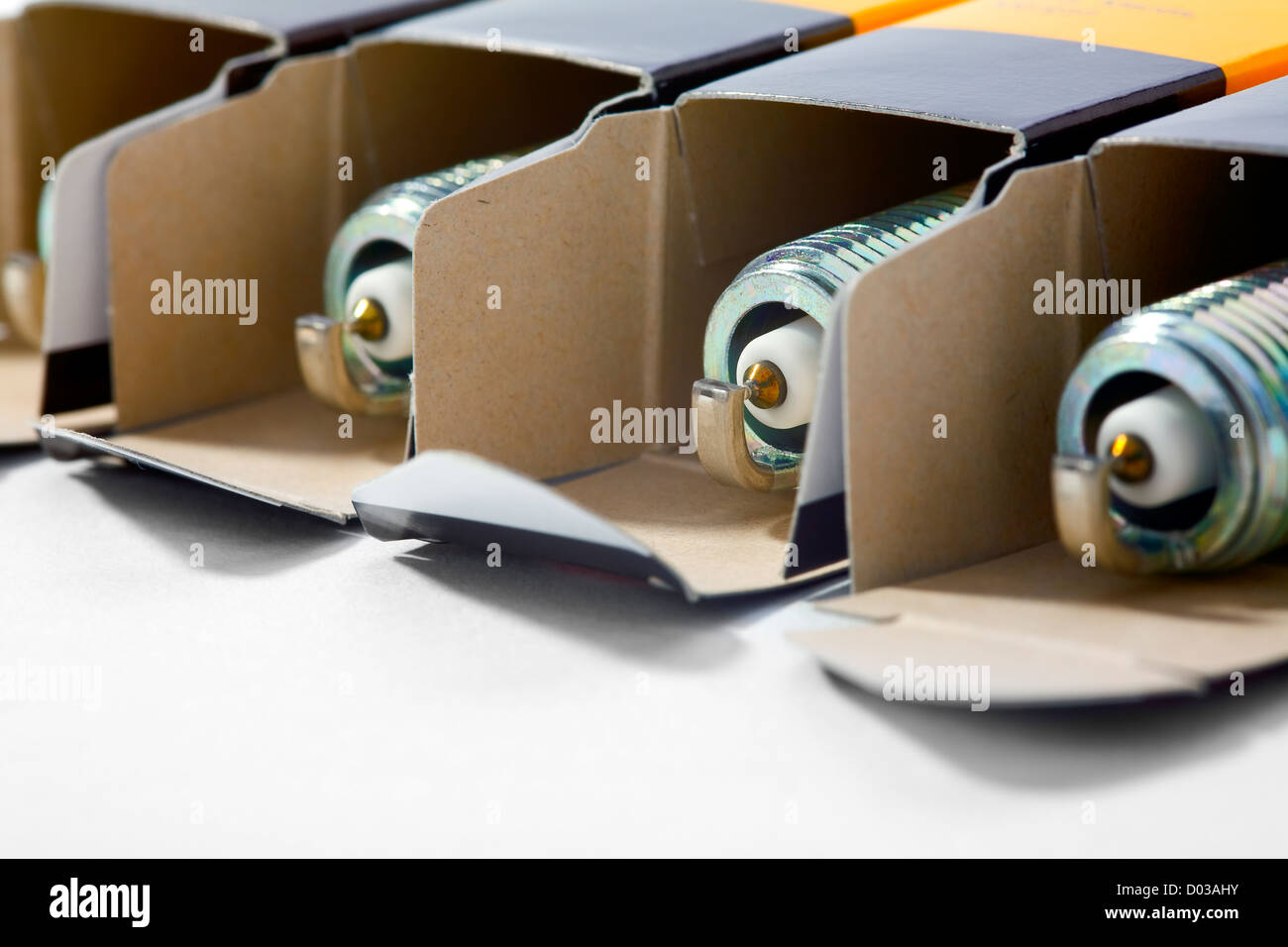Close up of a spark plugs in a cardboard box on white background Stock ...