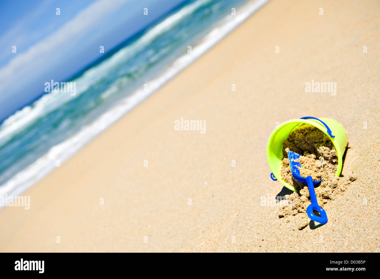 Toy bucket and shovel on an empty beach Stock Photo - Alamy