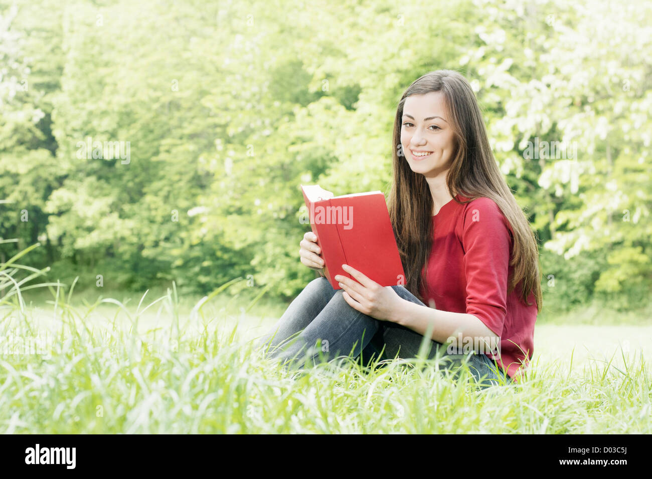 Young student reading book outdoors Stock Photo - Alamy