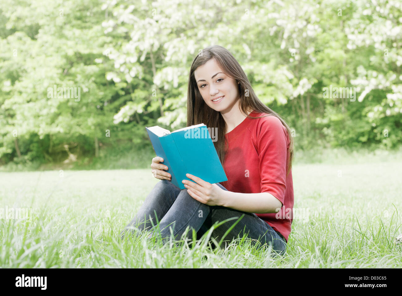 Young student reading book outdoors Stock Photo - Alamy