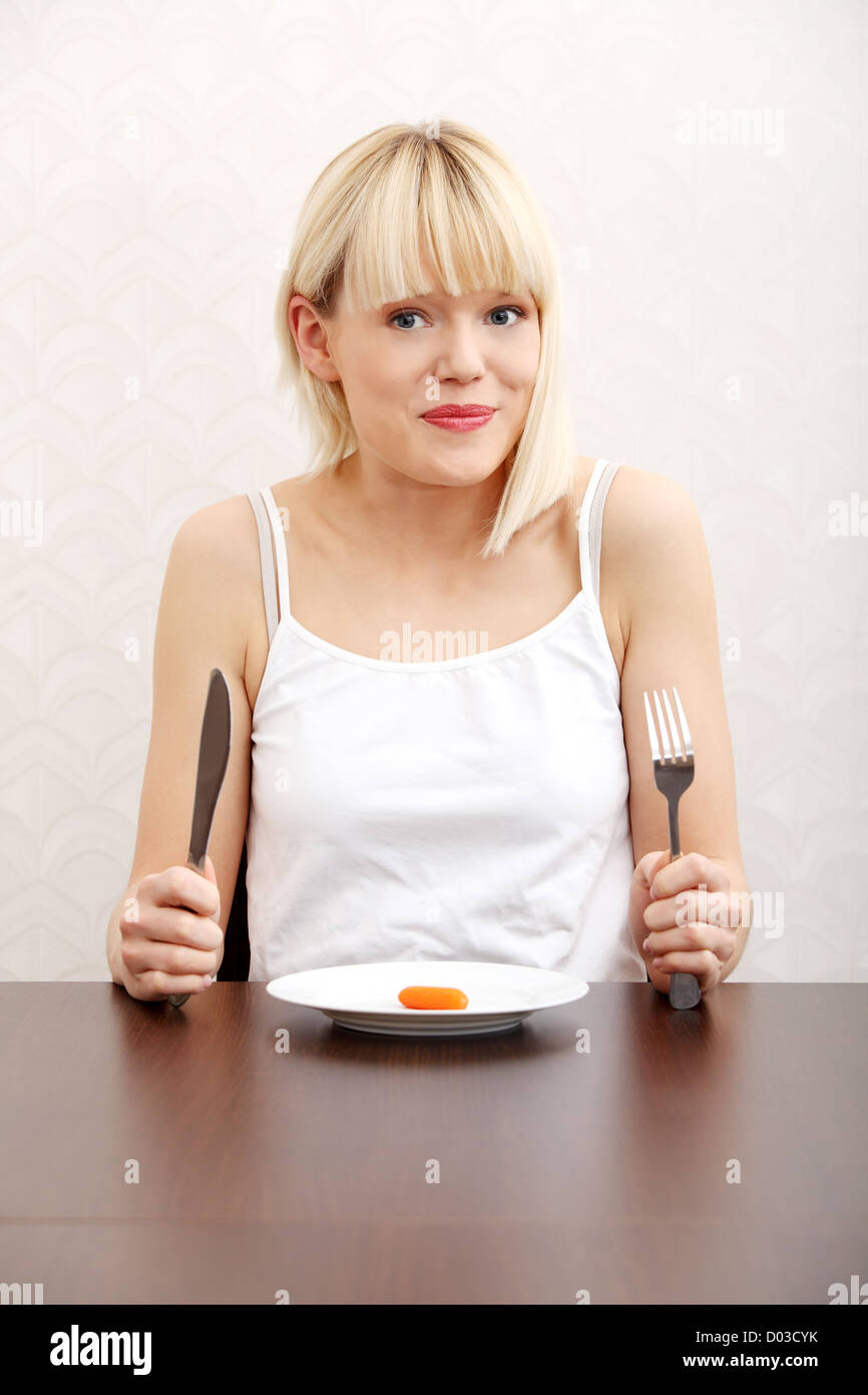 Beautiful woman eating carrot Stock Photo - Alamy