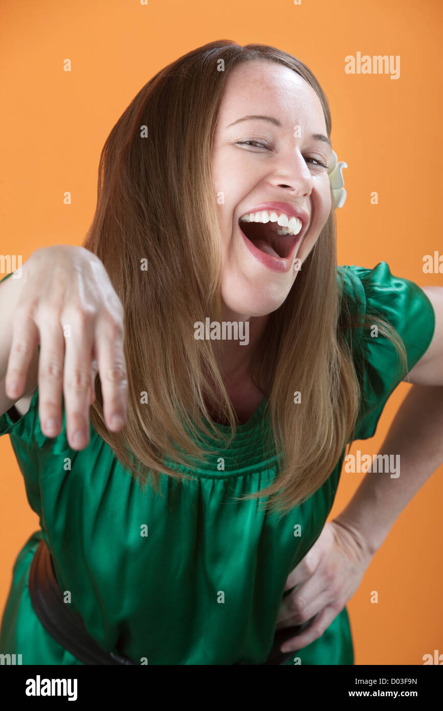 Laughing Caucasian woman sticks her hand out Stock Photo - Alamy