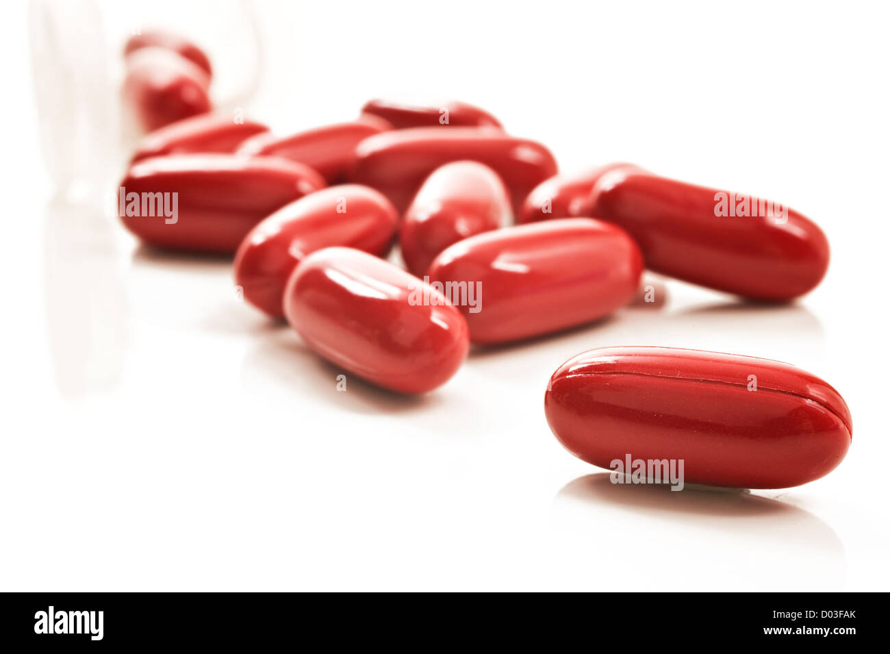 Red pills and pill bottle Stock Photo - Alamy
