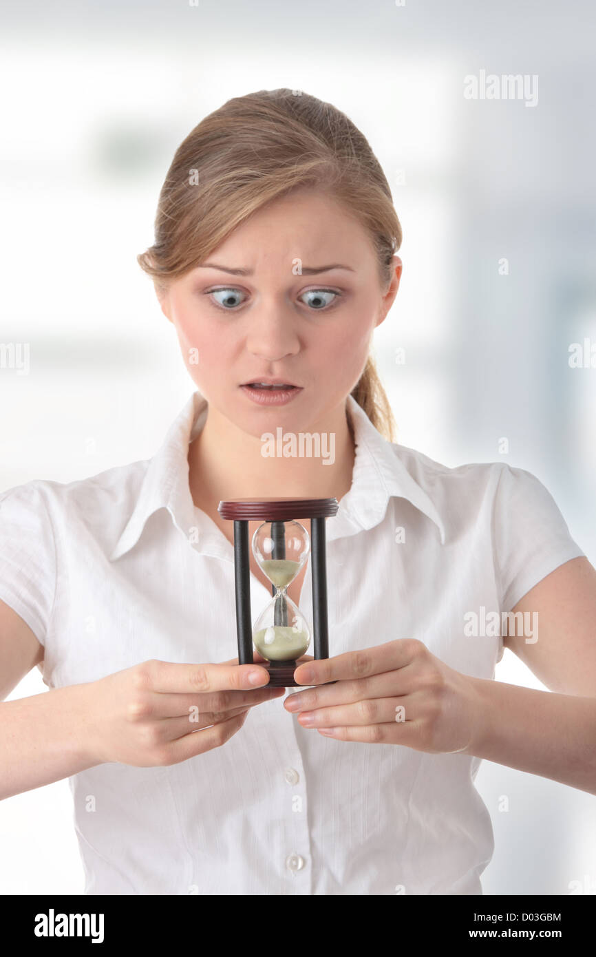 Young business woman with hourglass - time concept Stock Photo - Alamy
