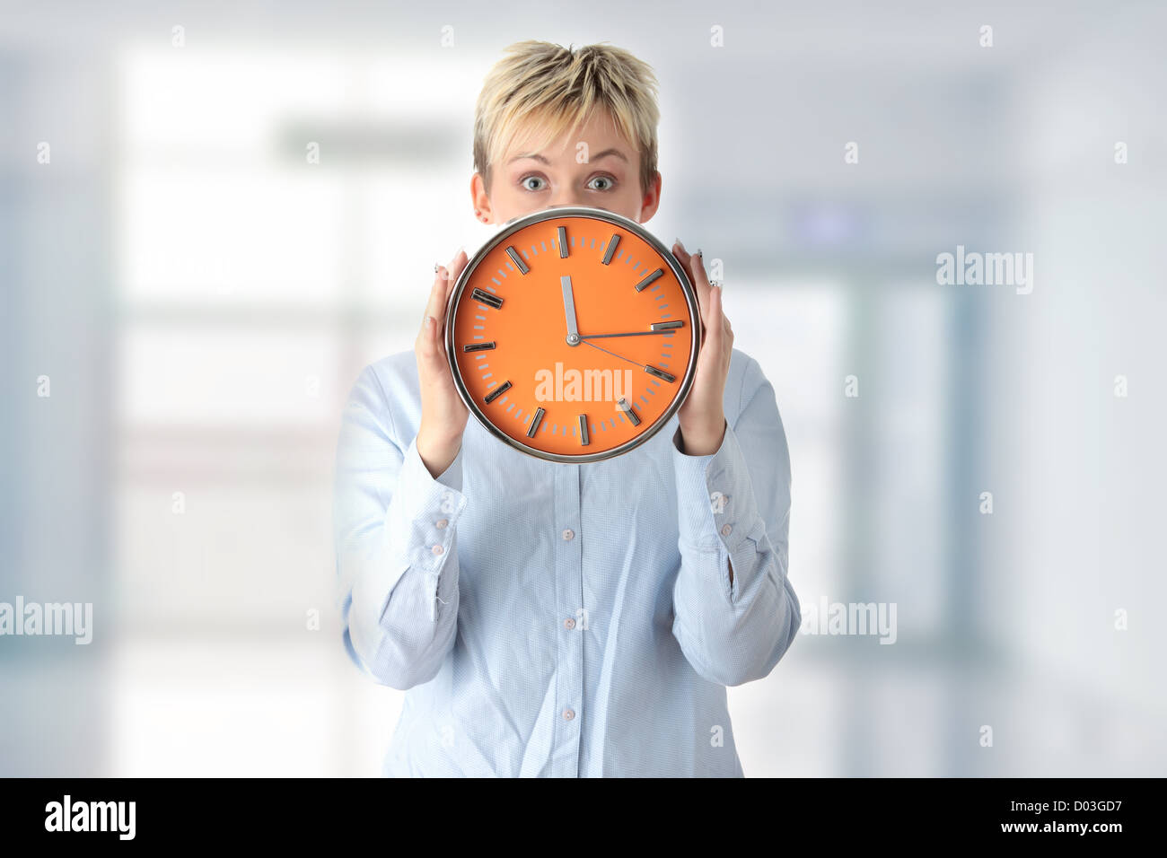 Woman holding big alarm clock Stock Photo - Alamy