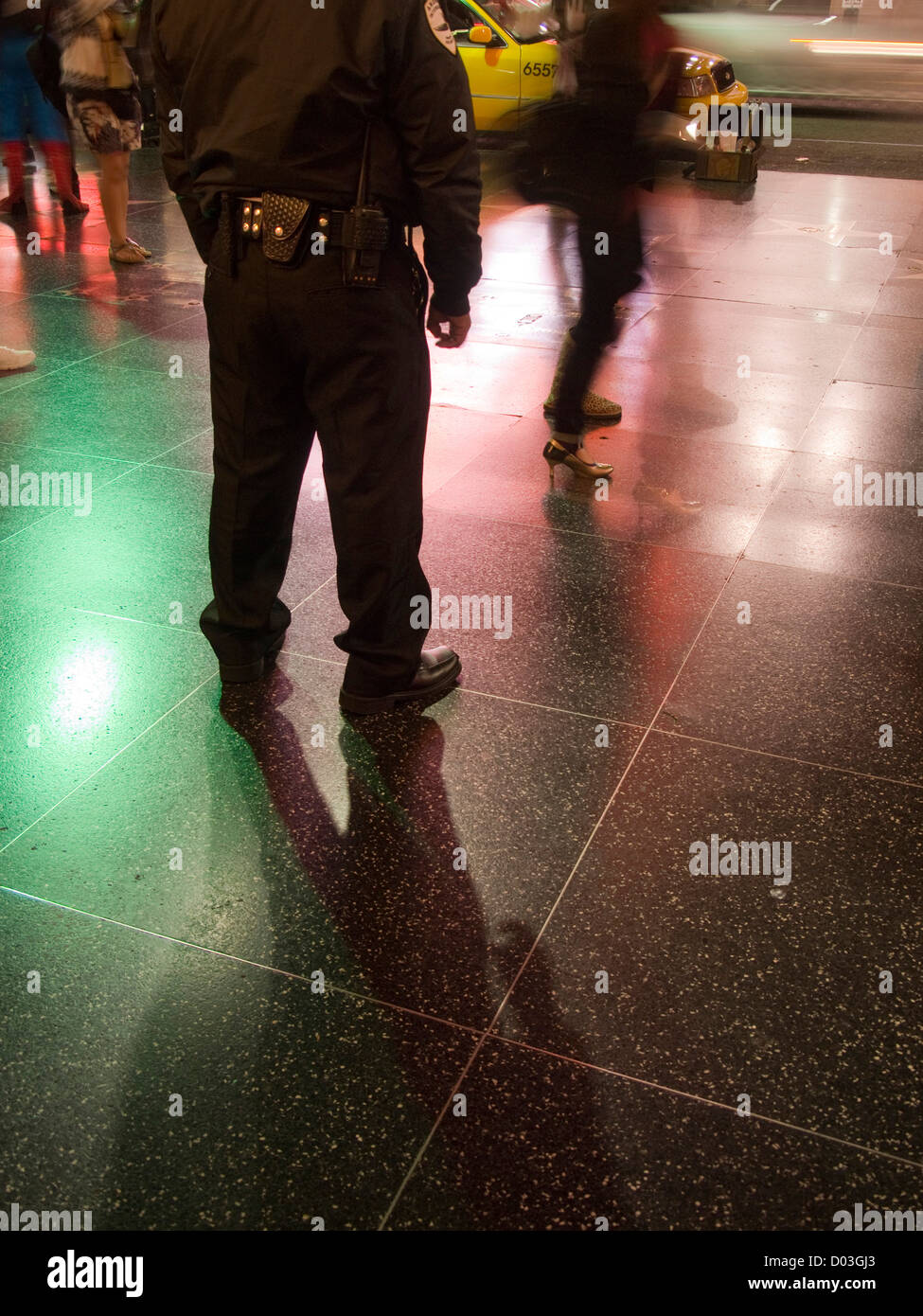 A security guard stands outside on a street in Los Angeles, California ...
