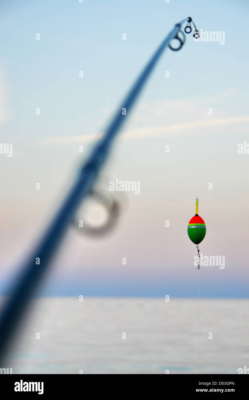 Fishing pole waiting to be cast, with line and sinker Stock Photo - Alamy