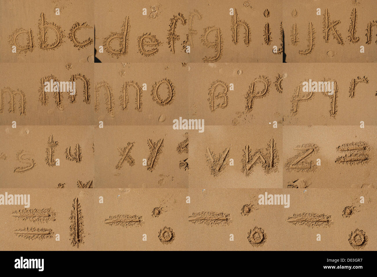 The alphabet written in sand on a beach Stock Photo - Alamy