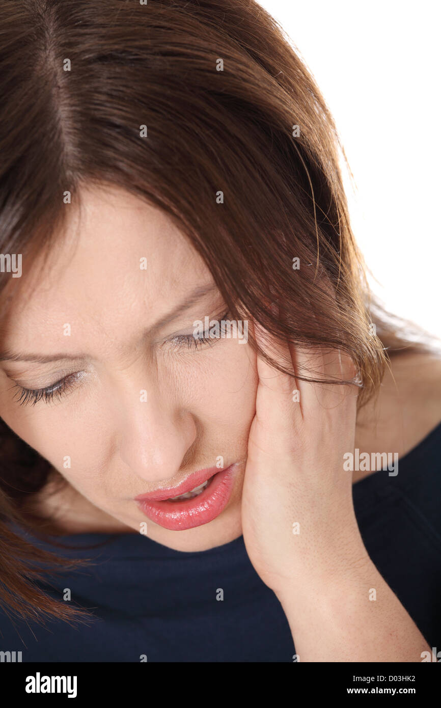 Attractive woman in her 40s pressing her bruised cheek with a painful ...