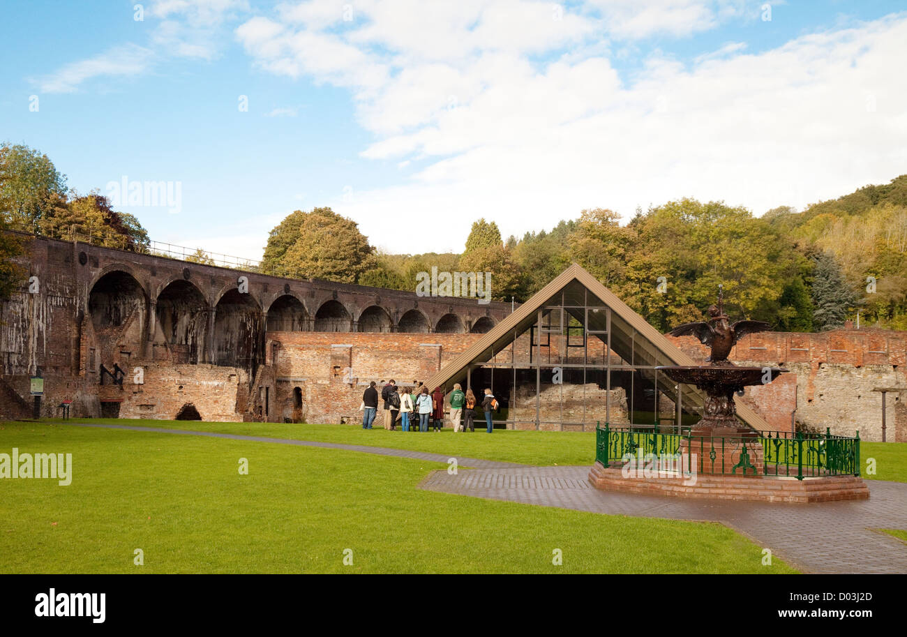 Visitors to the Museum of iron look at the old furnace and upper works ...