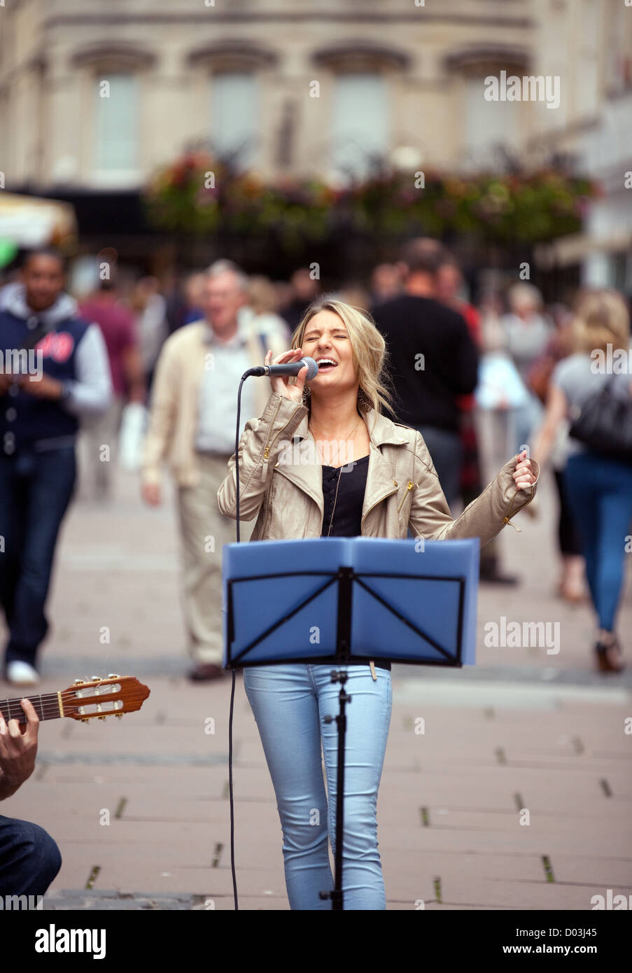 Street singer UK; A woman street performer singing on the streets of ...