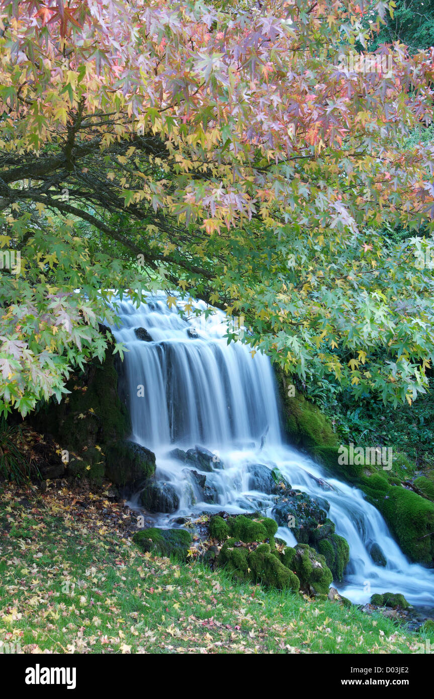 Autumn leaves overhang picturesque waterfall hi-res stock photography ...
