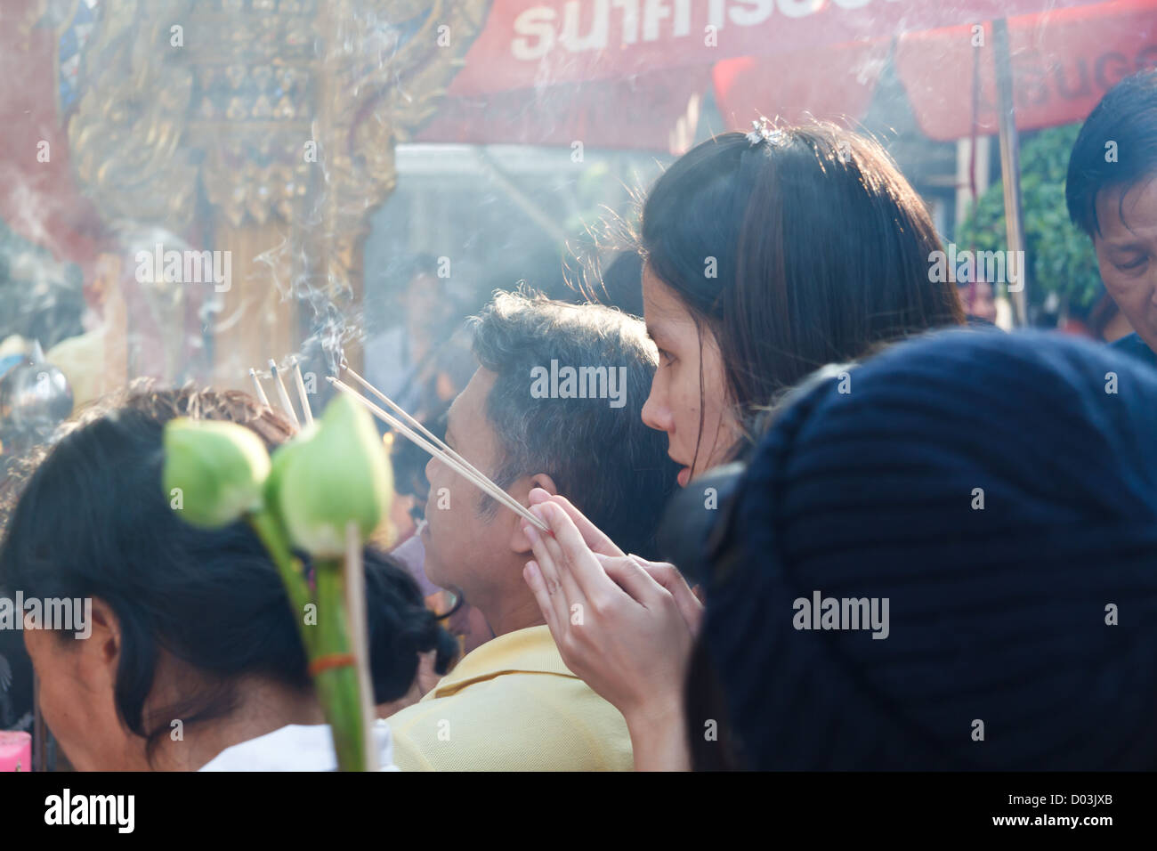 Buddhist Believers praying in a Temple in Bangkok, Thailand Stock Photo ...