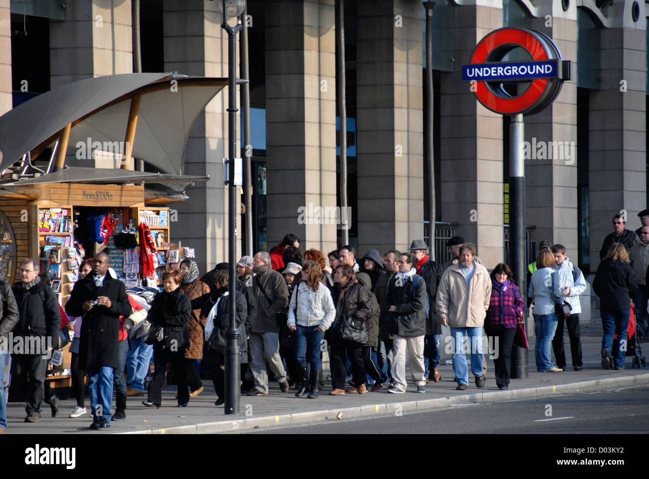 Crowded pavement and underground sign in fron of Portcullis House ...