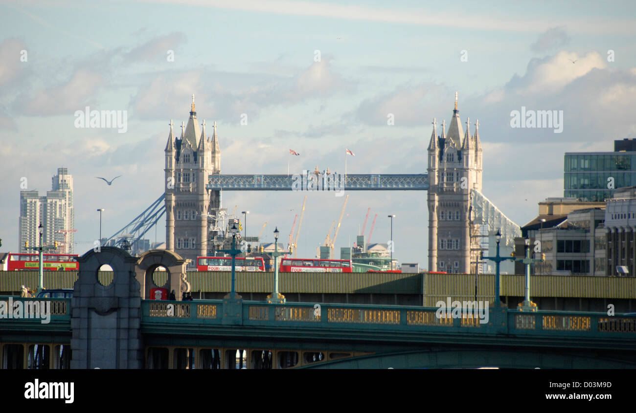 Southwark Bridge wih red bouble-decker busses, Tower Bridge in the ...